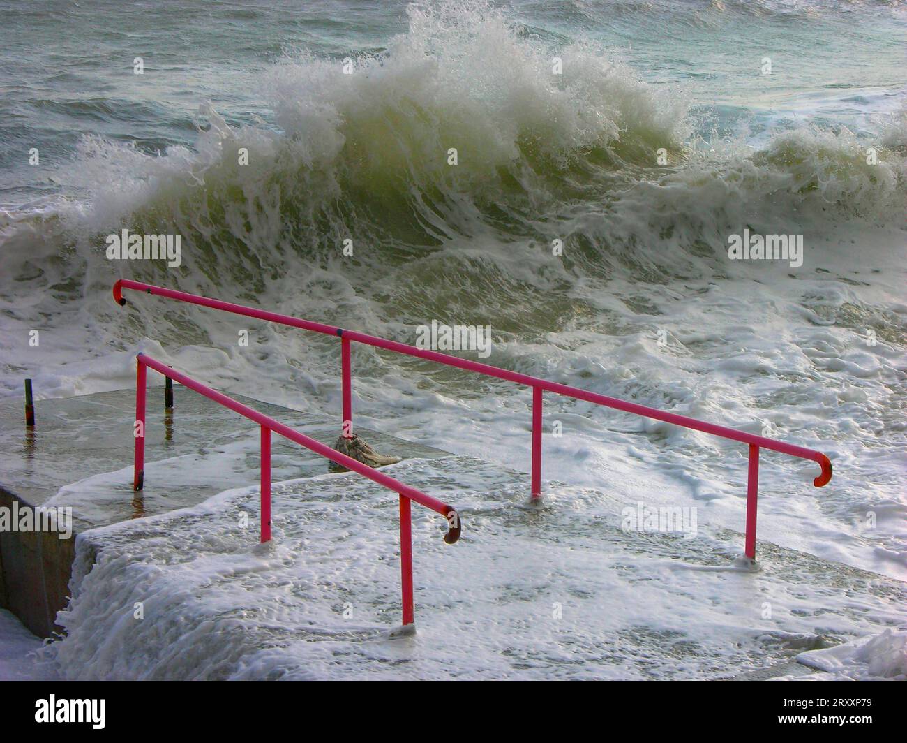 Sea waves, railing Stock Photo - Alamy