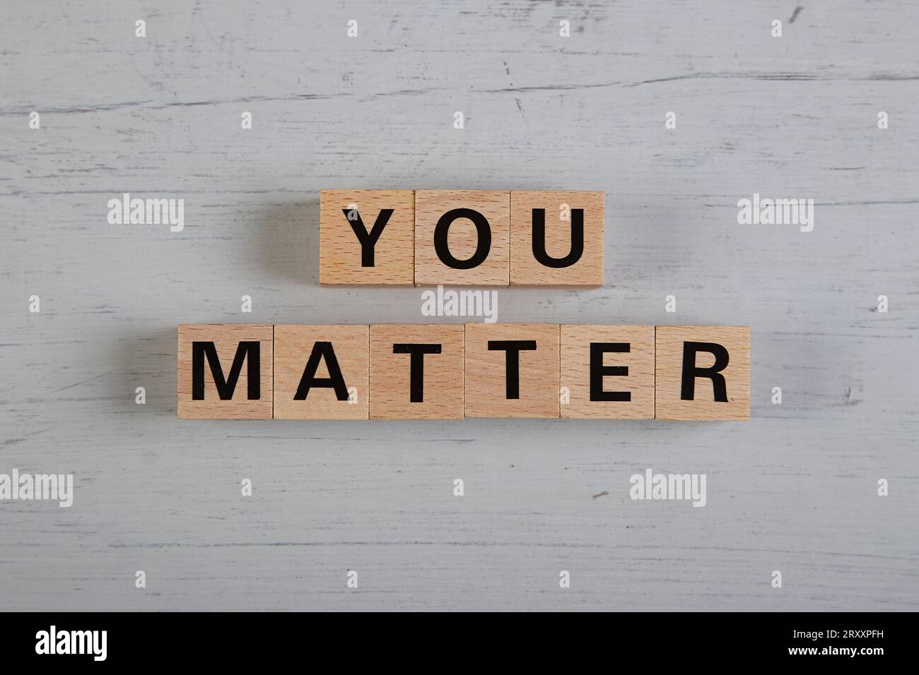 wooden blocks in a white and grey board with the text you matter Stock ...