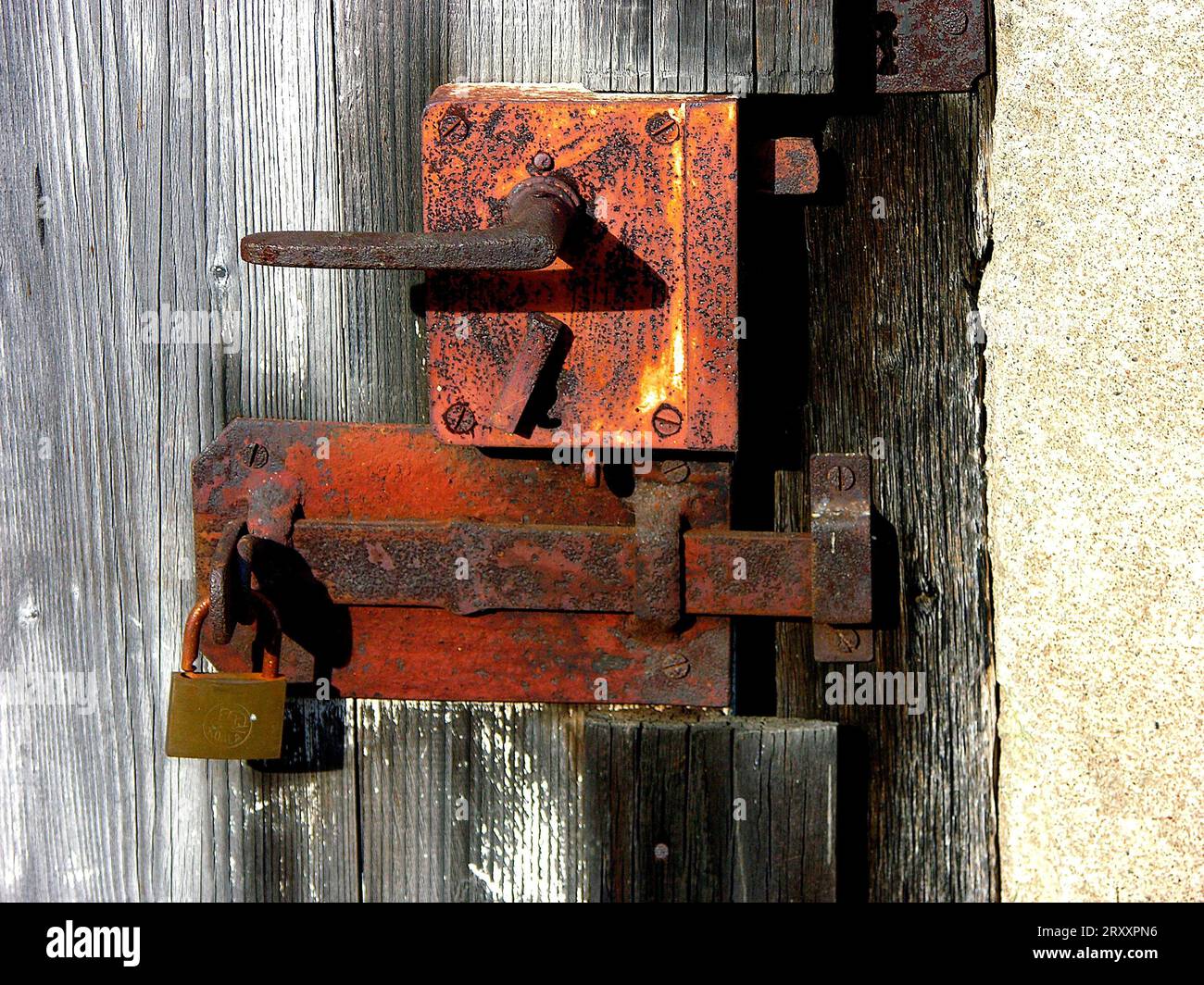 Old rusty door lock on wooden gate Stock Photo - Alamy