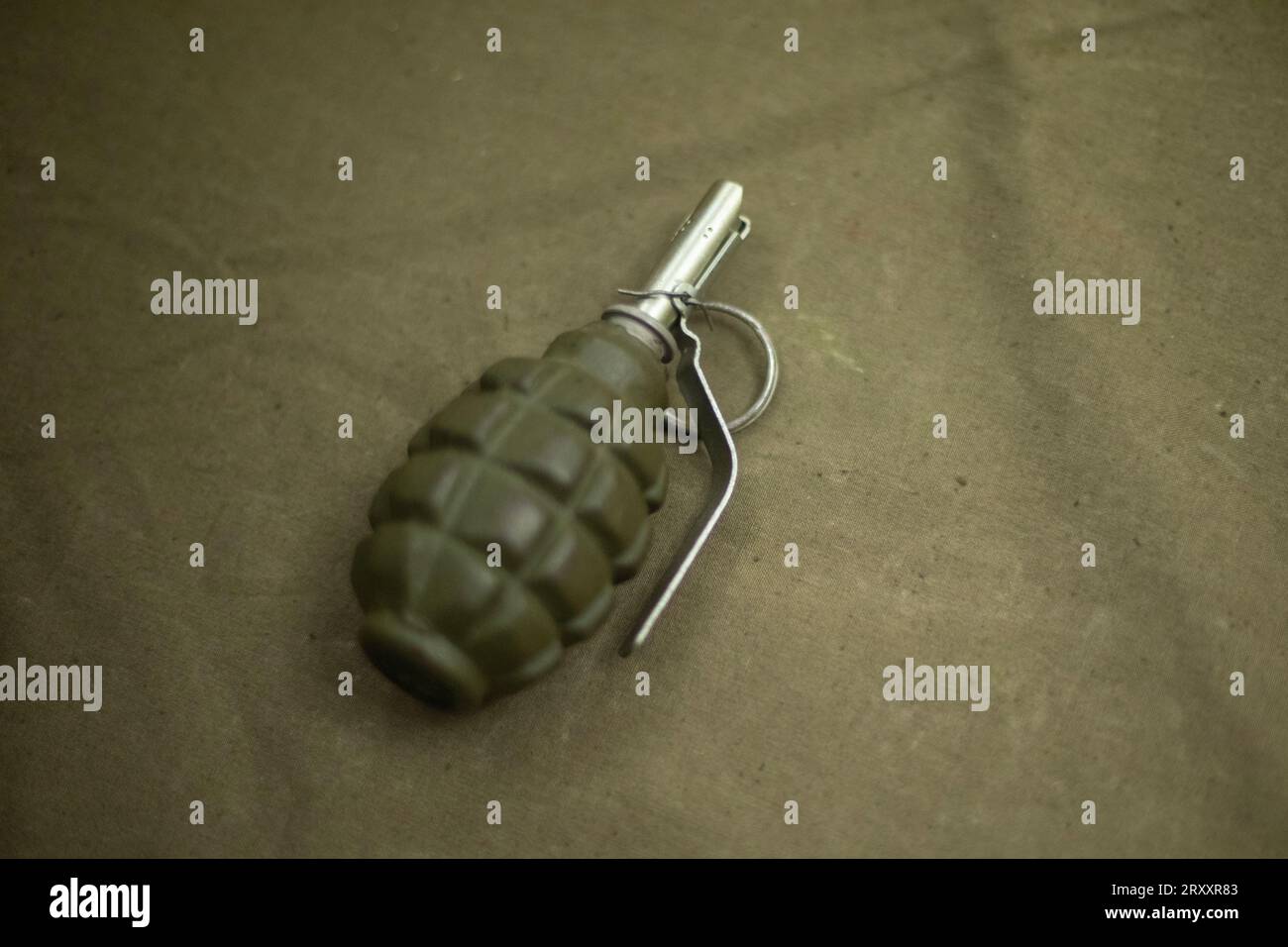 Grenade is lying on table. Military ammunition. Green explosives ...