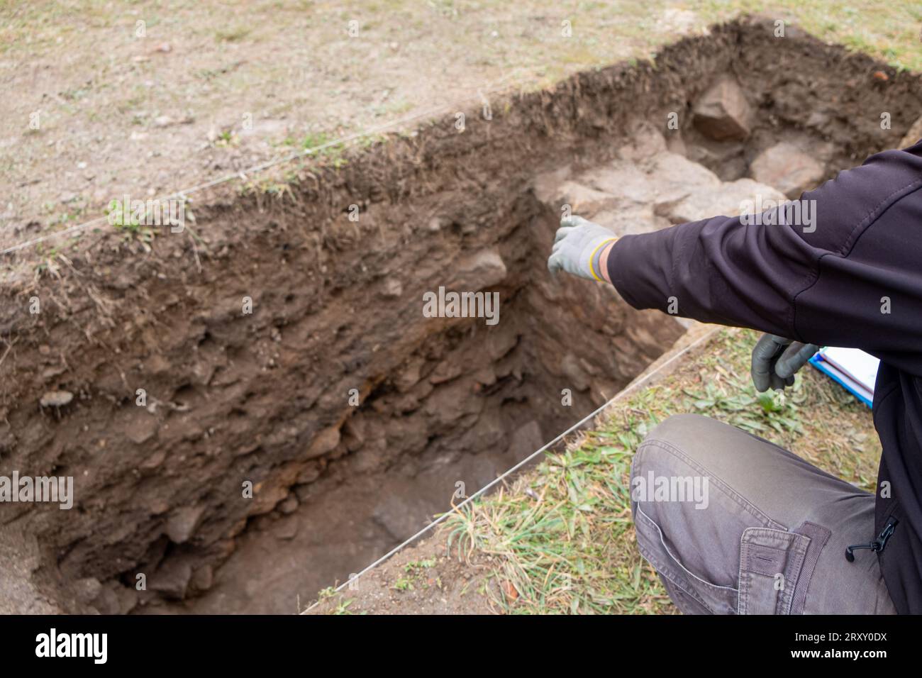 Selective focus, an archaeologist explaining an archaeological ...