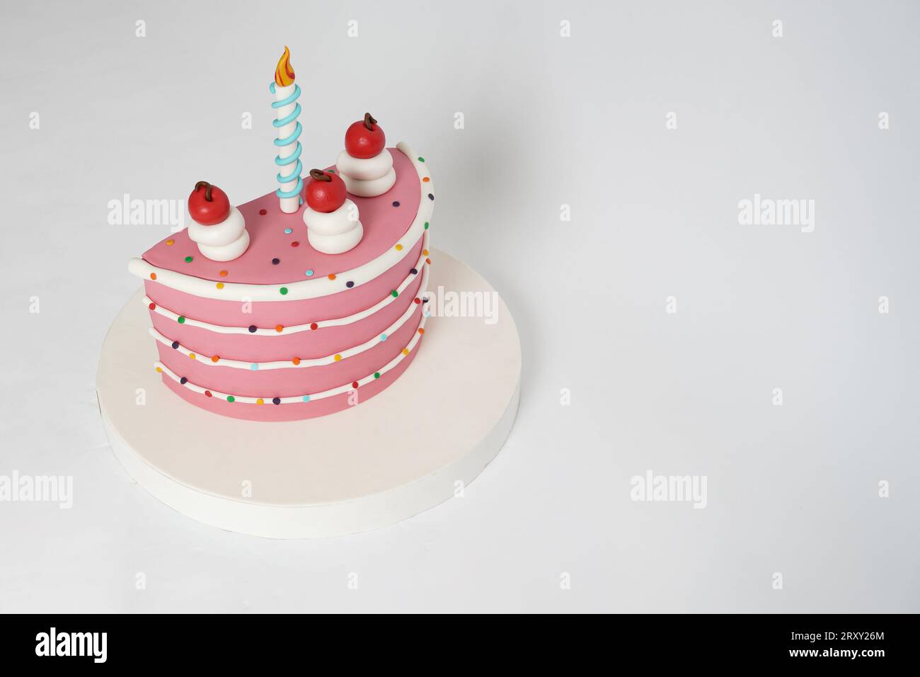 Half Birthday cake. A cute pink half cake with candle and cherry on ...