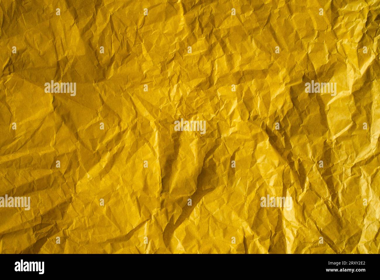 Yellow crinkled wrapping paper with a lot of texture. Concept ...