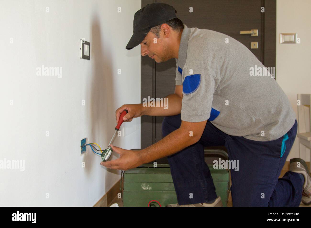 Image of a handyman electrician repairing and installing a home ...