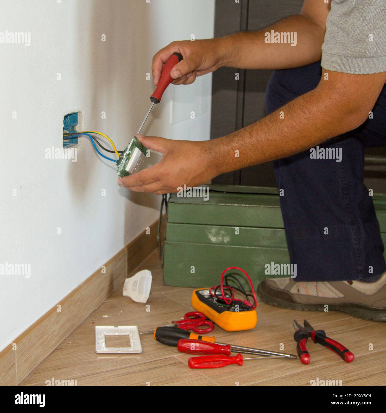 Image of a handyman electrician repairing and installing a home ...