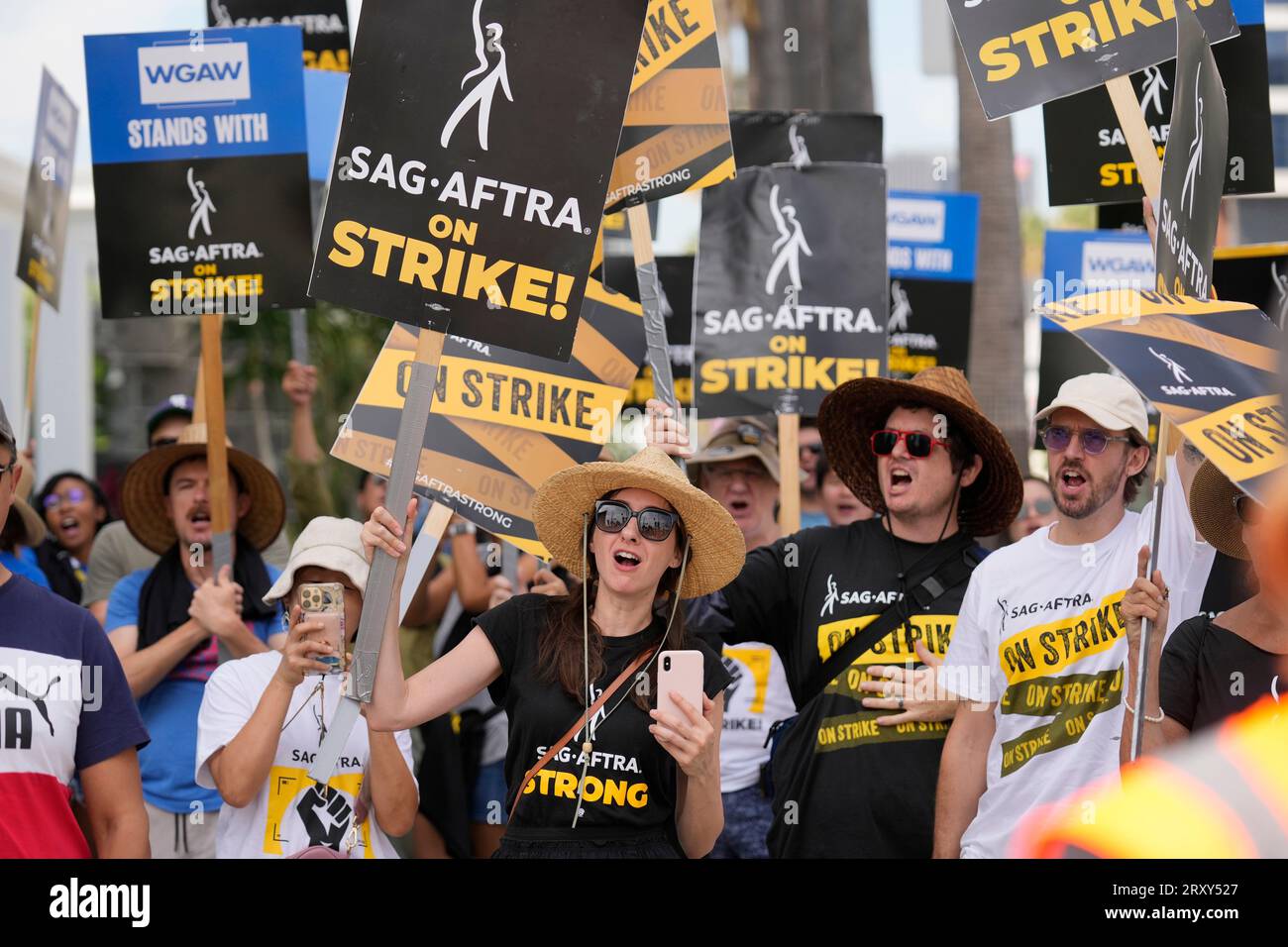 Picketers carry signs on the picket line outside Netflix on Wednesday ...
