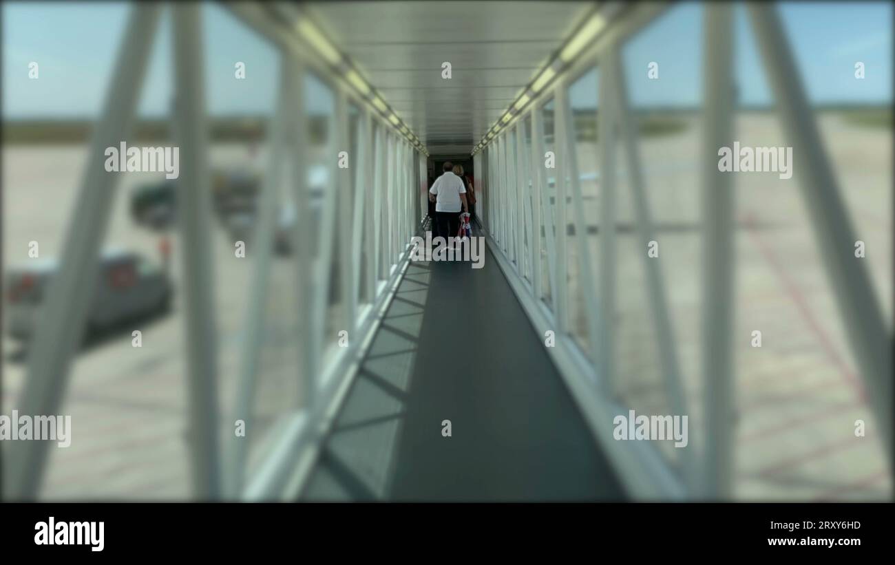 Passenger perspective boarding plane corridor. POV person walking ...