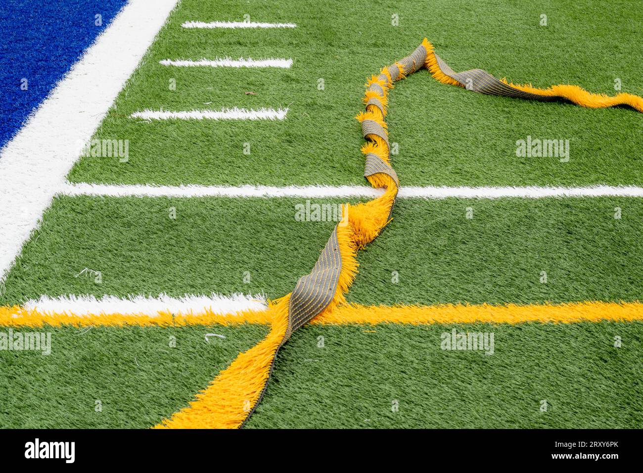 Synthetic turf field under construction with lines and graphics being ...
