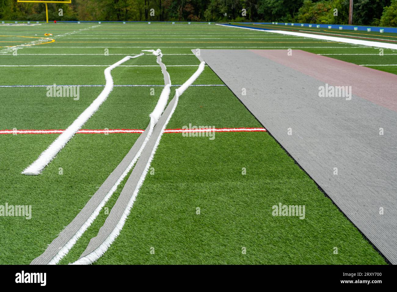 Synthetic turf field under construction with lines and graphics being ...