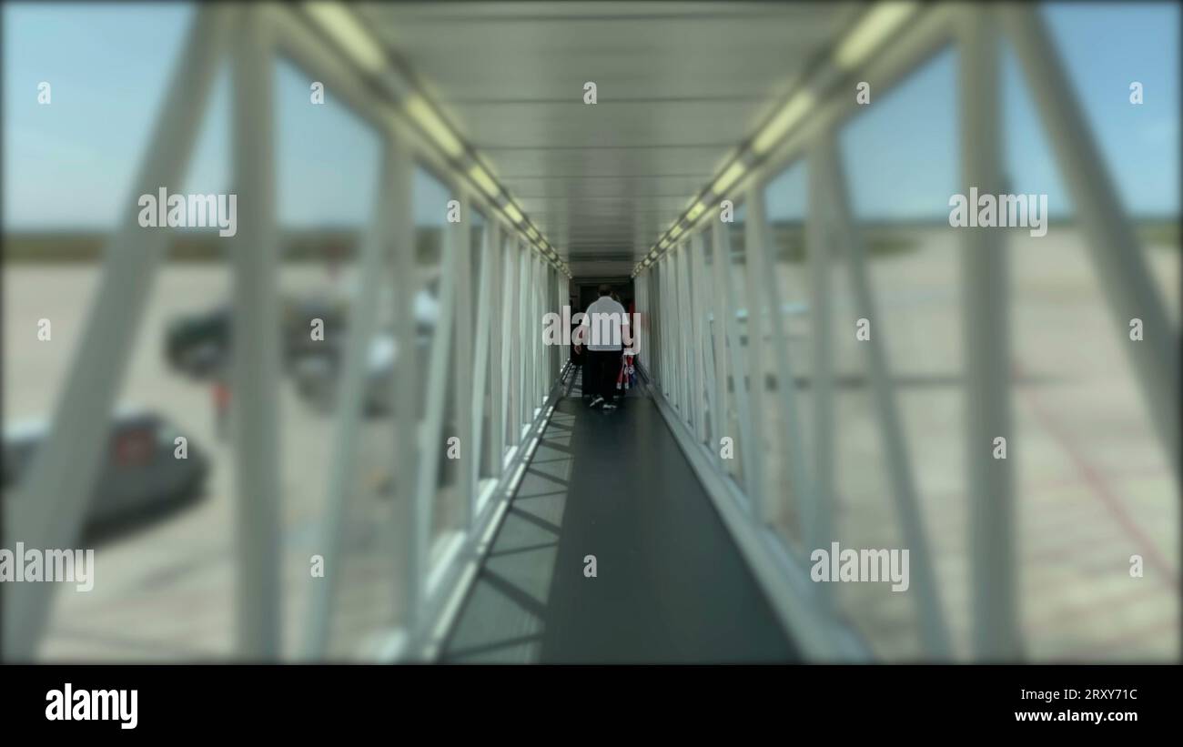Passenger perspective boarding plane corridor. POV person walking ...