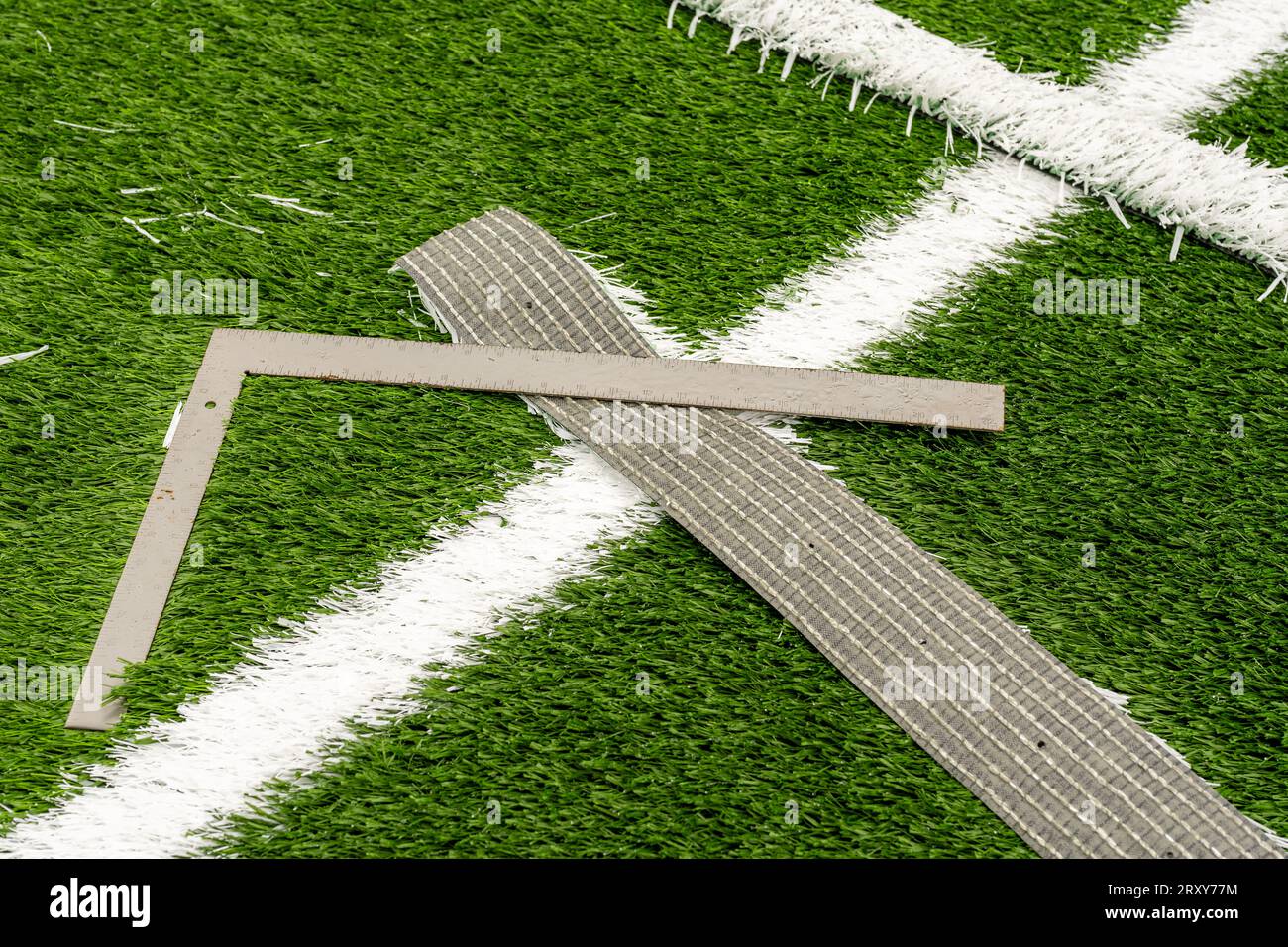 Synthetic turf field under construction with lines and graphics being ...