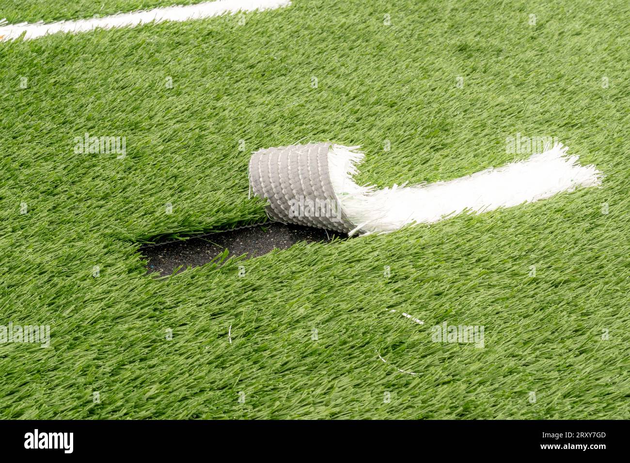 Synthetic turf field under construction with lines and graphics being ...