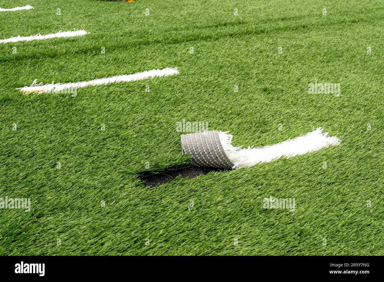 Synthetic turf field under construction with lines and graphics being ...