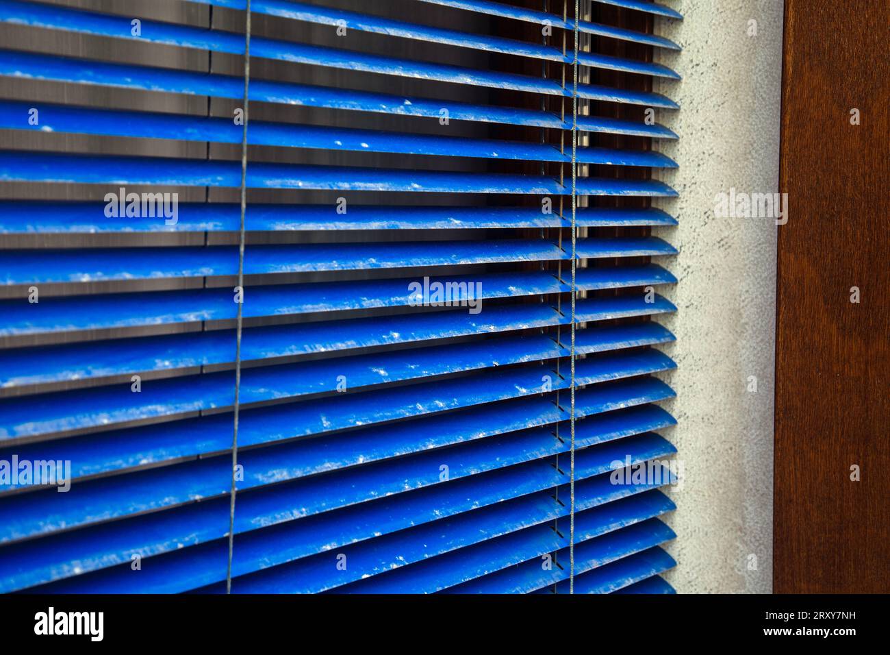 The blue slats of a Venetian blind shot in landscape format for use as ...