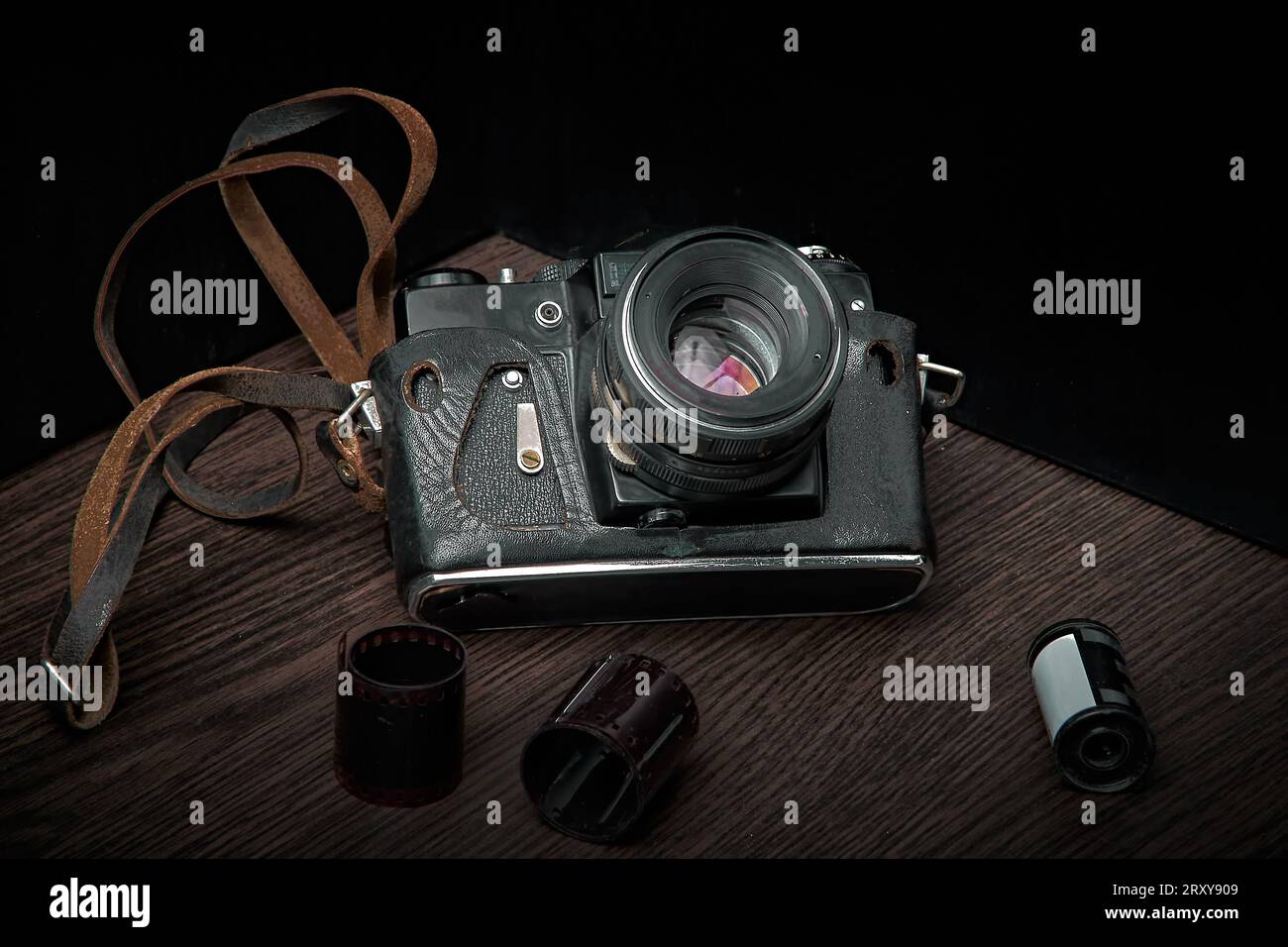 Old film SLR camera for 35 mm film in a worn case, top view Stock Photo ...