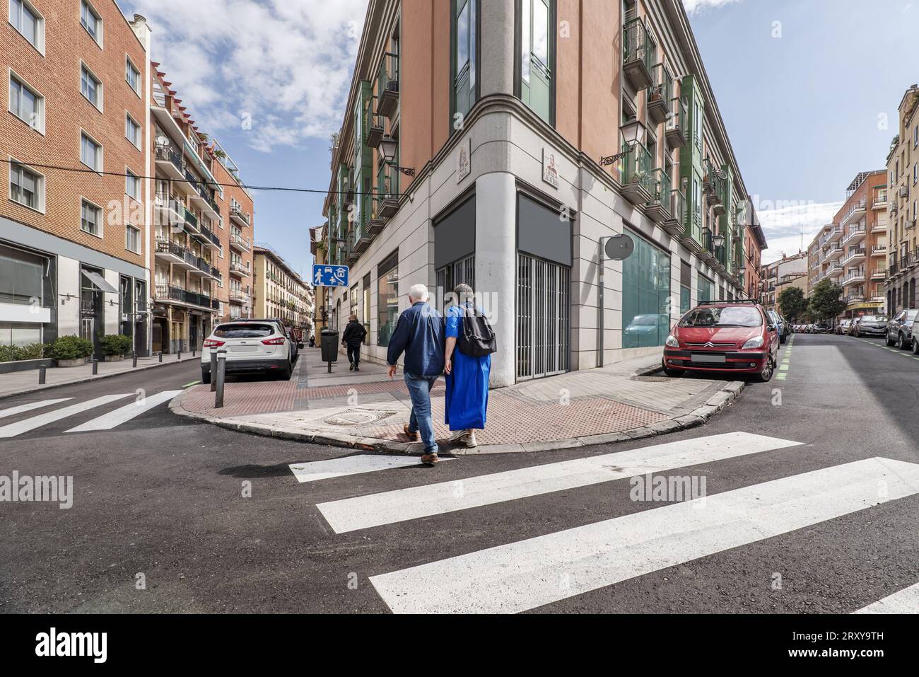 Crossing streets in an urban neighborhood with commercial premises on ...