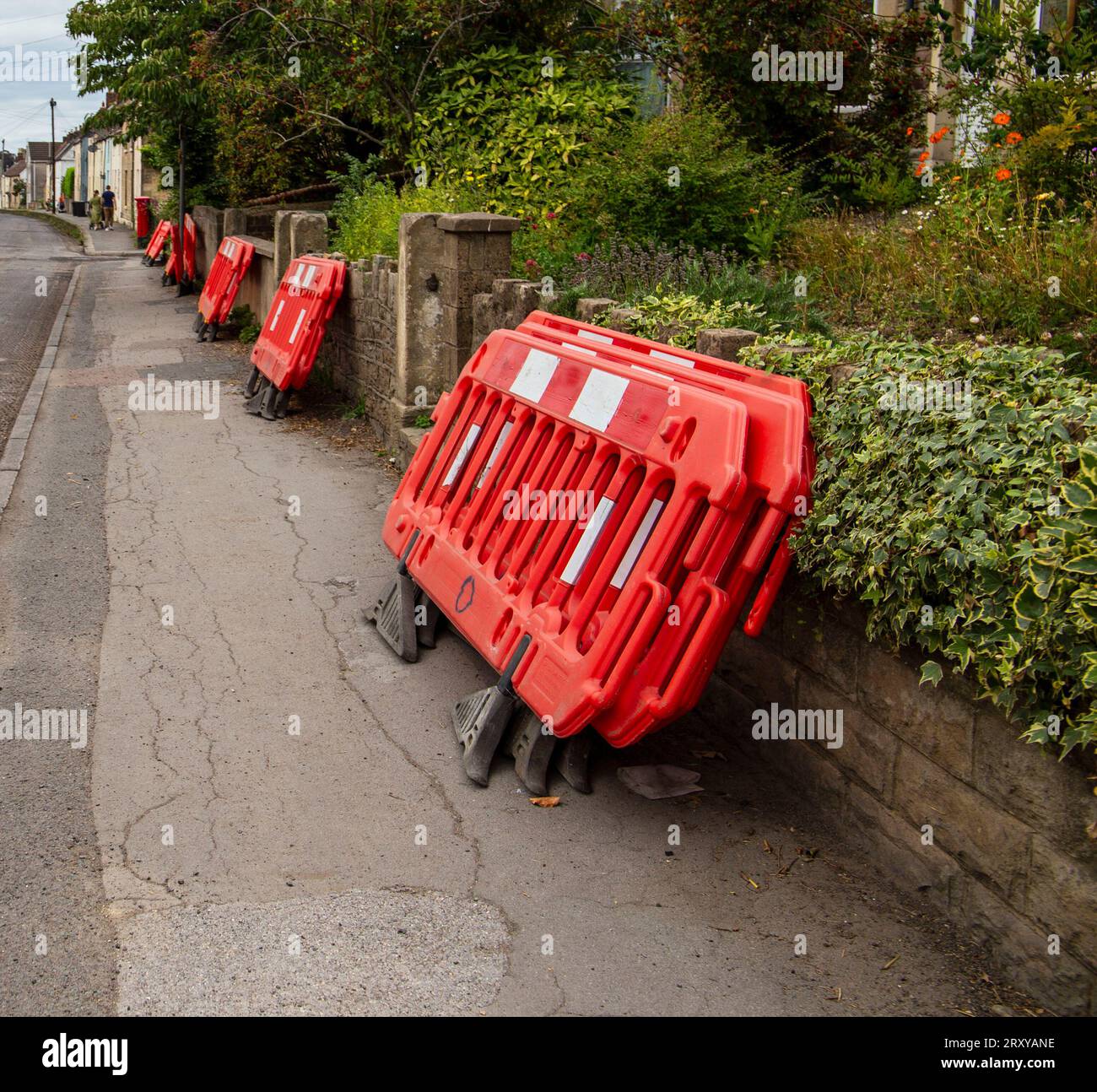 Plastic red barriers stacked on the pavement ready for use Stock Photo ...