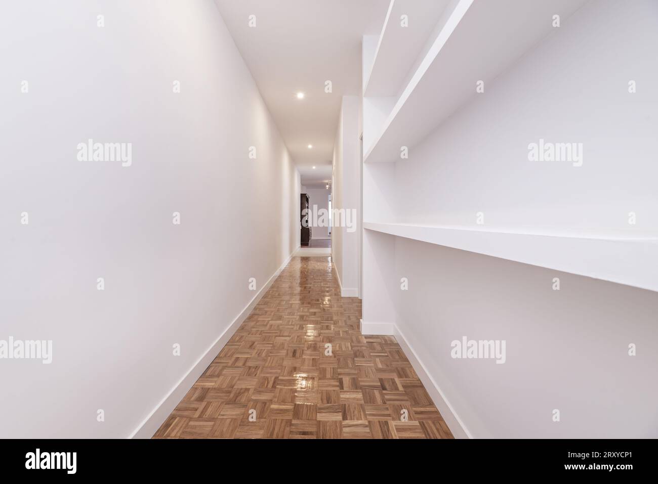 A long hallway with access to several rooms in a recently painted Stock ...