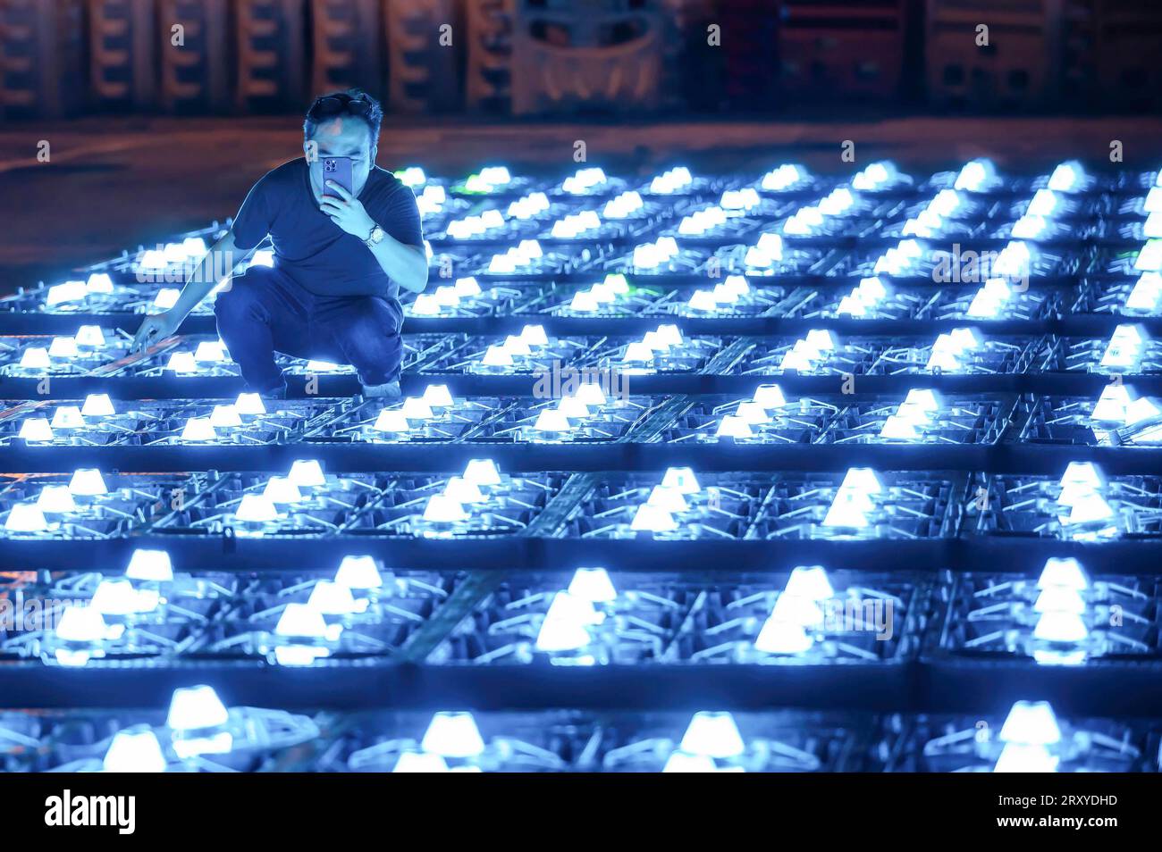 A man takes a photo of hundreds of drones near the Wanchai waterfront ...