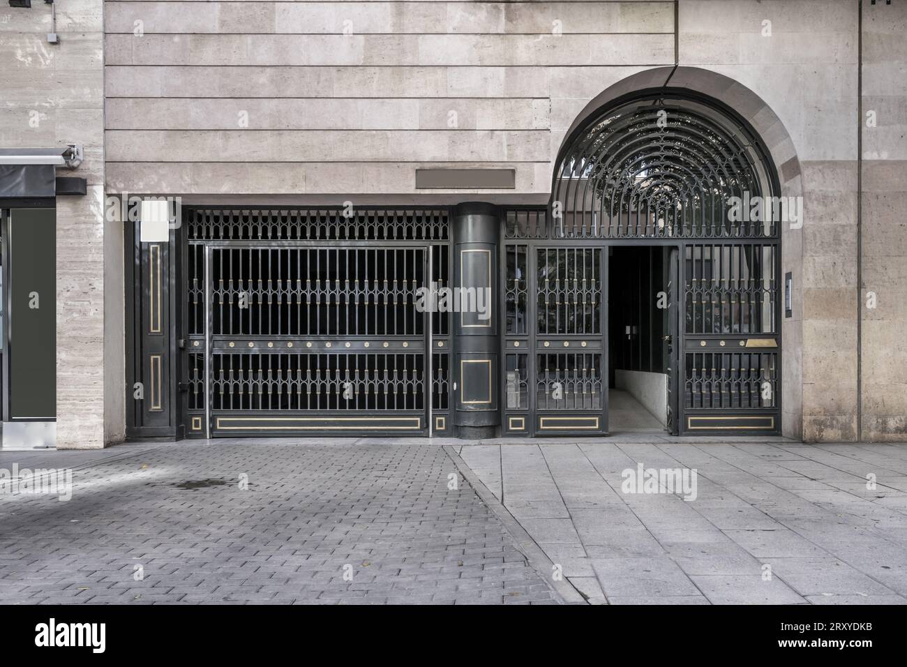 Access portal to a building with black metal doors, brass details Stock ...