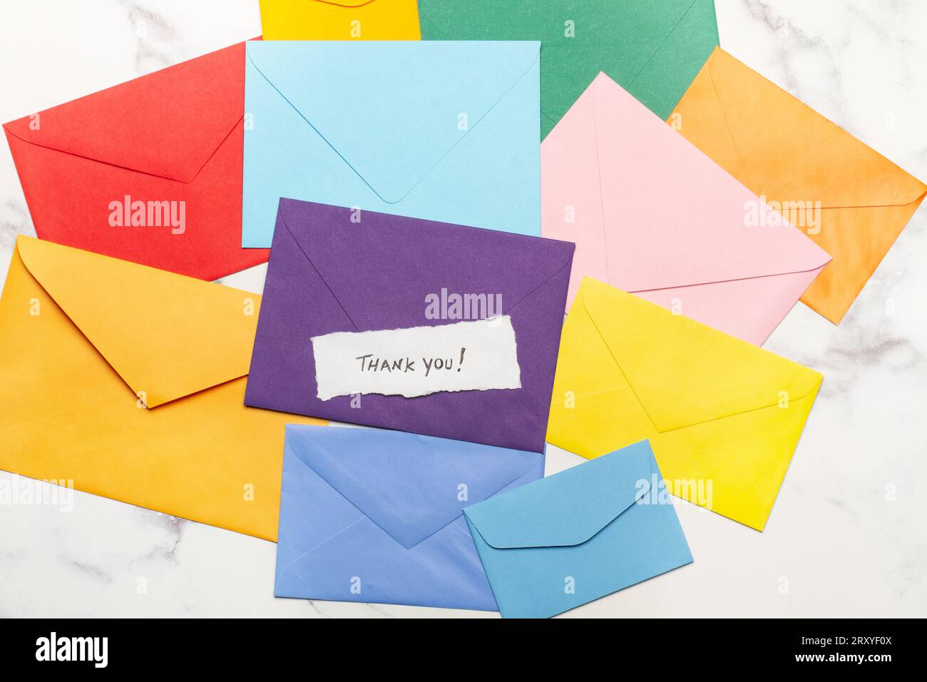 Colored envelopes and a thank you note on a marble kitchen counter in a ...