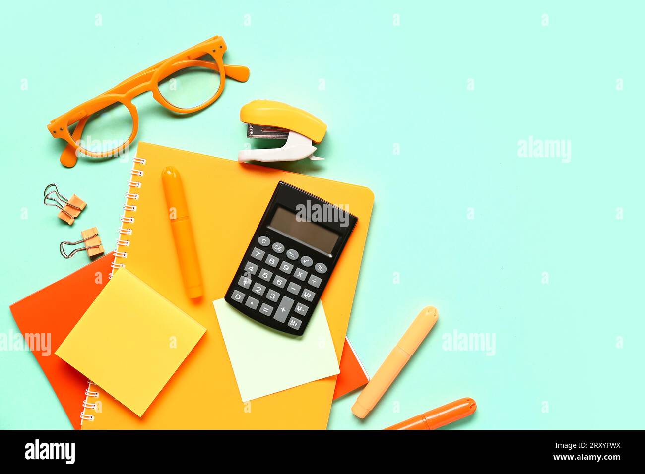 Modern calculator with stationery on turquoise background Stock Photo ...