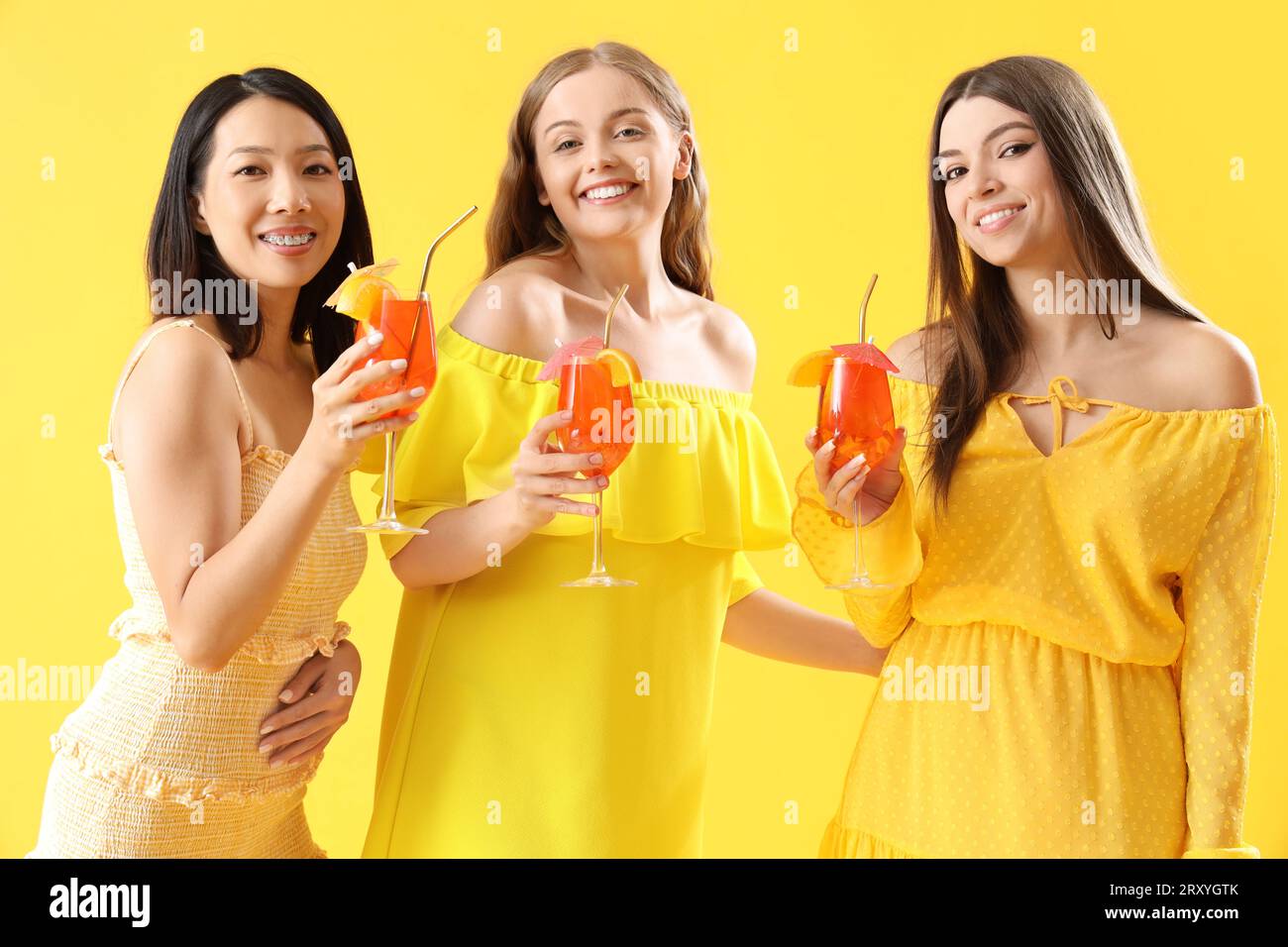 Beautiful young women with glasses of tasty aperol spritz cocktail on ...