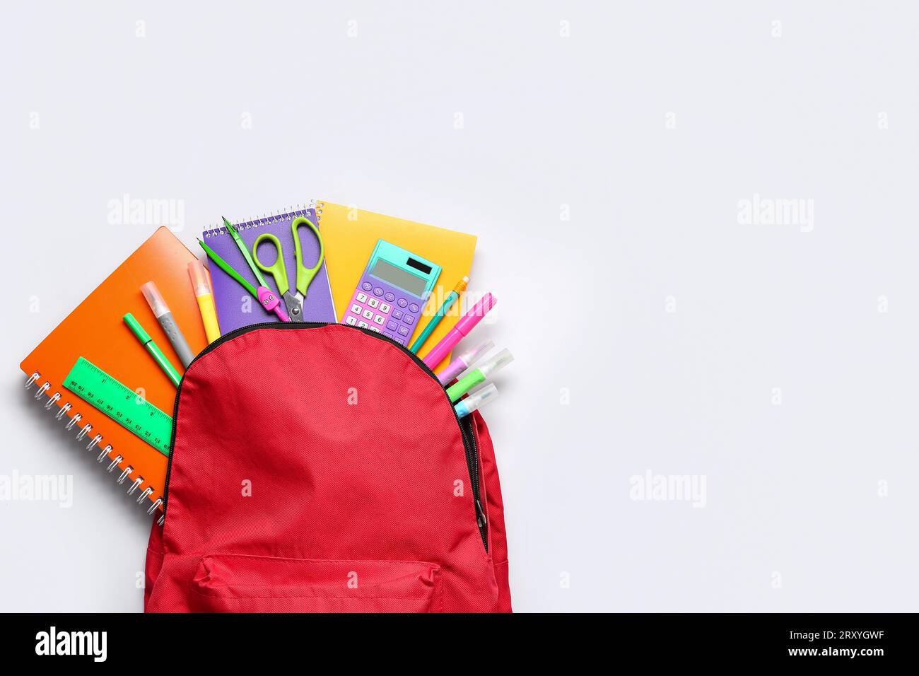 Composition with red school backpack and different stationery on white ...