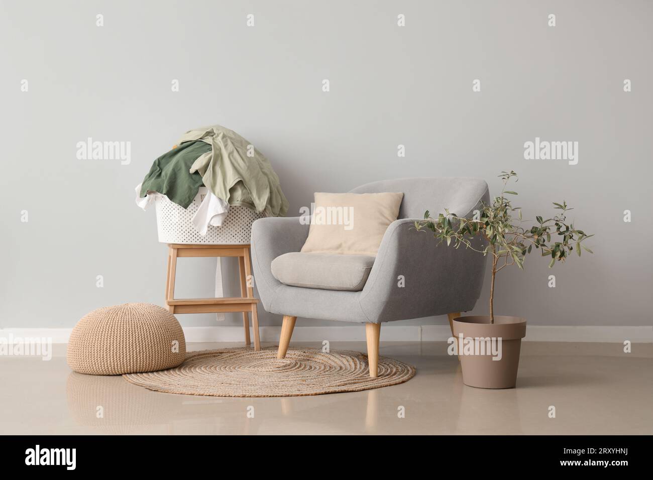 Interior of living room with armchair and dirty clothes Stock Photo - Alamy