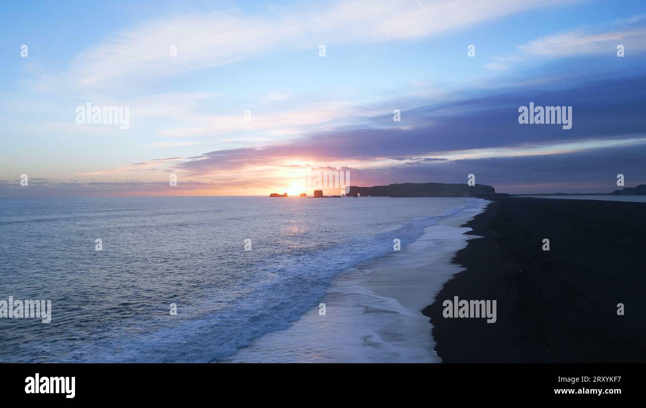 Reynisfjara black sand beach in iceland, beautiful scenery with sunset ...