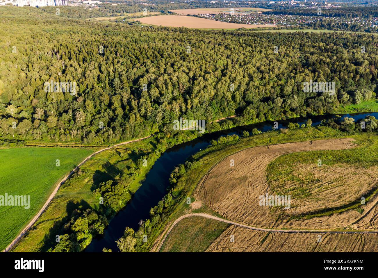 Flight over a picturesque green landscape. View from above of the river ...