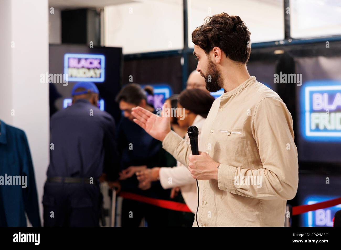 Event host holding microphone announces start of Black Friday sale in ...