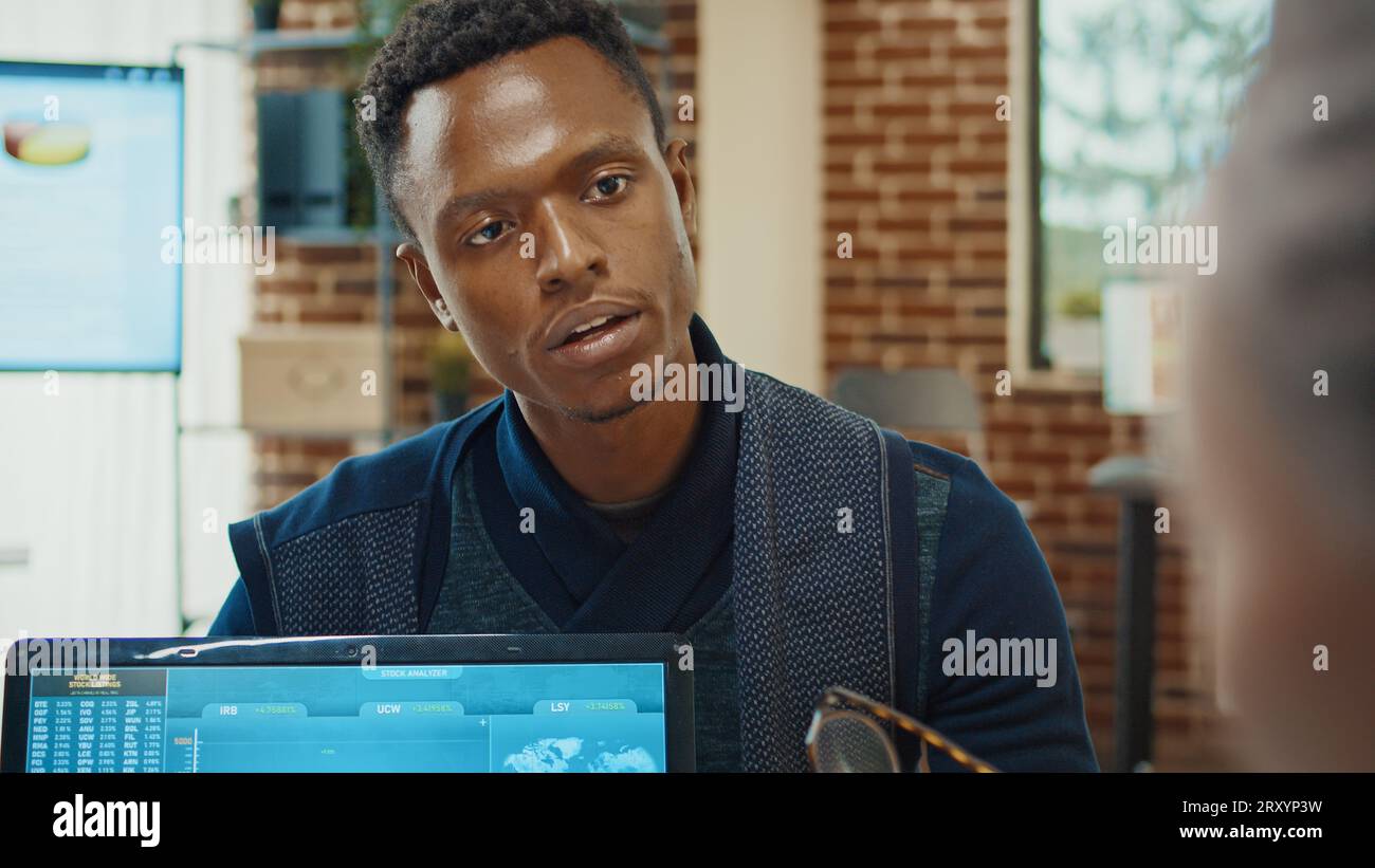 Collaborating coworkers examining data hi-res stock photography and ...