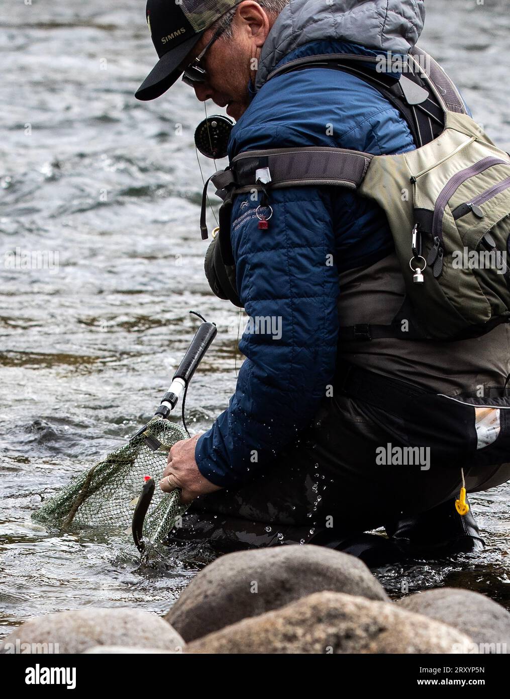 Todd Oishi, of Canada, catches an undersized rainbow trout at the 2023 Masters and Ladies World ...