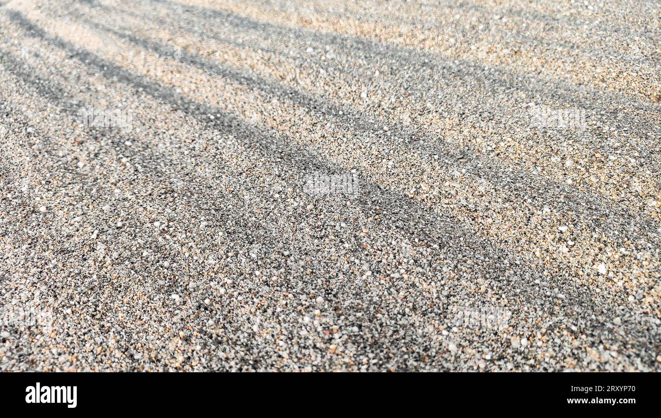 Textured beige sandy background with diagonal lines extending towards ...