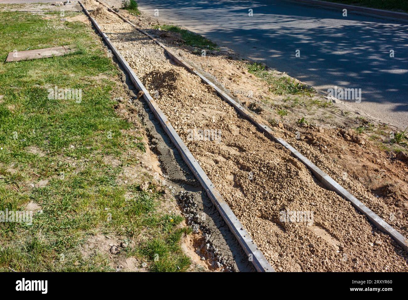 Work on laying a pedestrian path with curbs Stock Photo - Alamy