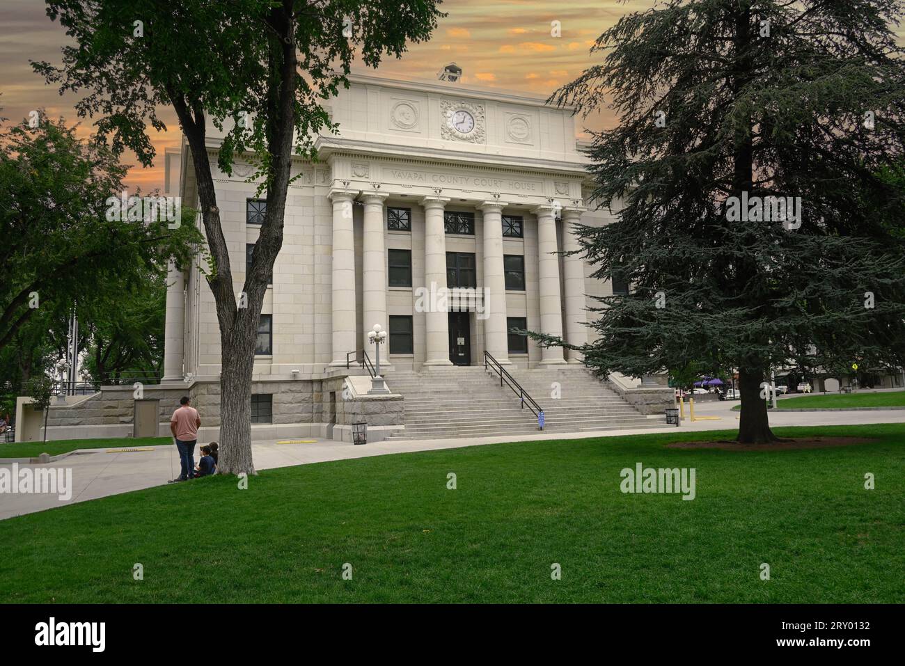 Grassy grounds and pine trees around the Yavapai County Courthouse, a ...