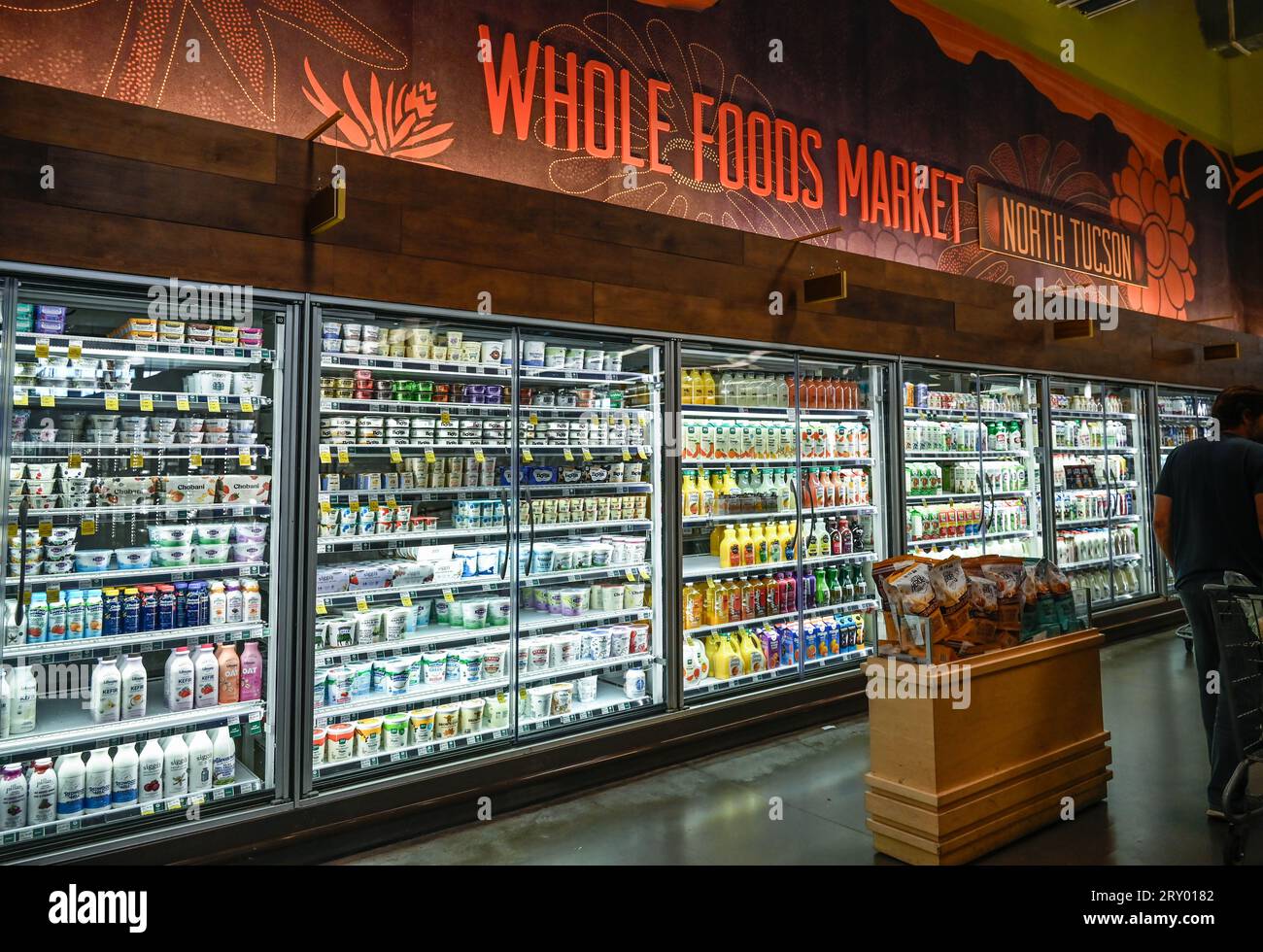 Interior of signage above a cooler display of assorted refrigerated ...