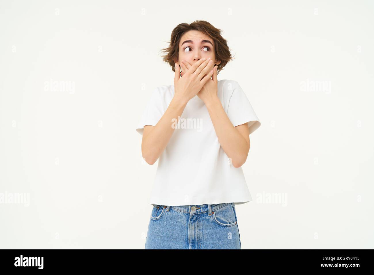 Portrait of woman with shocked, surprised face, covers her mouth with ...