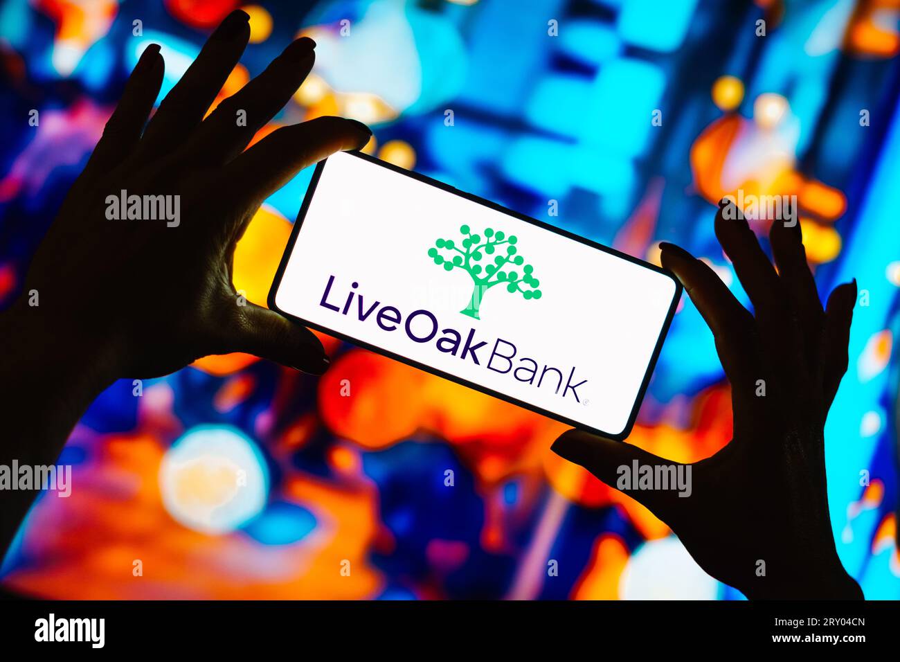 In this photo illustration, the Live Oak Bank logo is displayed on a ...