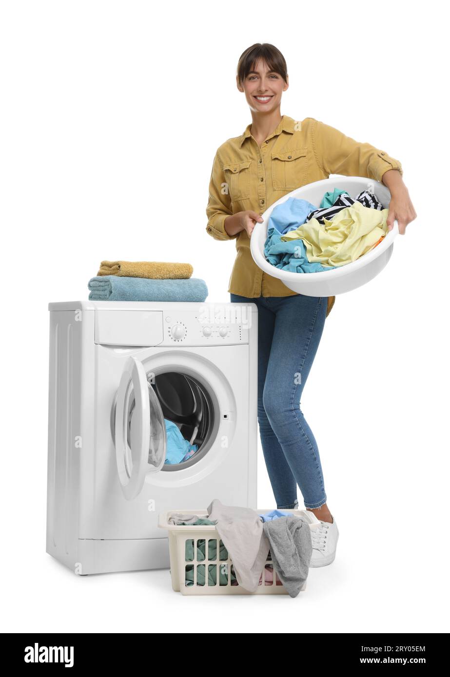 Beautiful woman with laundry near washing machine on white background Stock Photo - Alamy