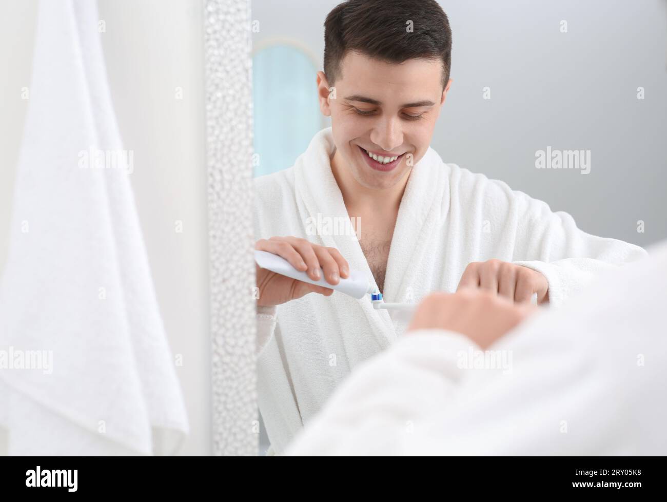 Squeezing toothpaste onto toothbrush hi-res stock photography and ...