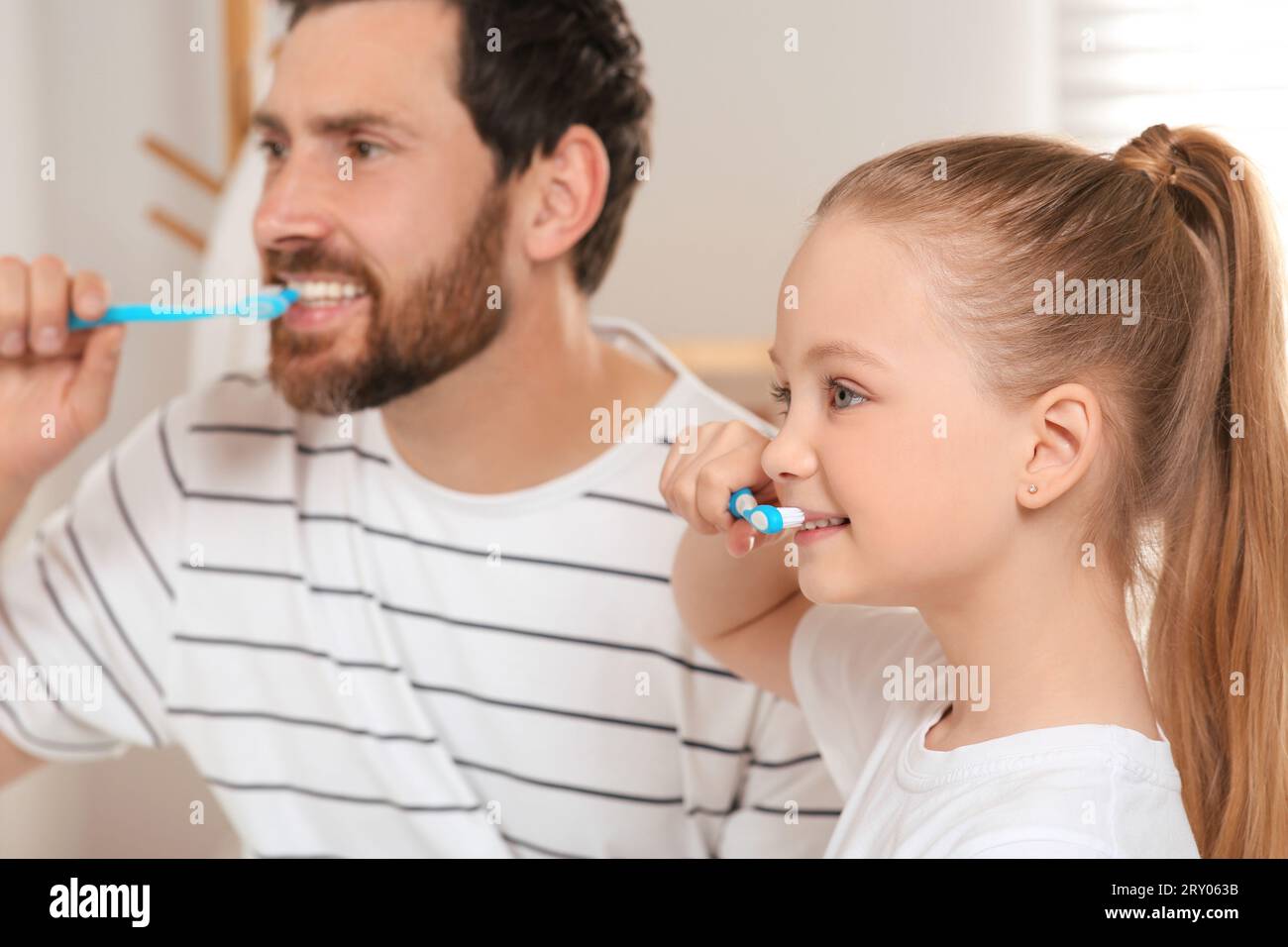 Father and his daughter brushing teeth together indoors Stock Photo - Alamy