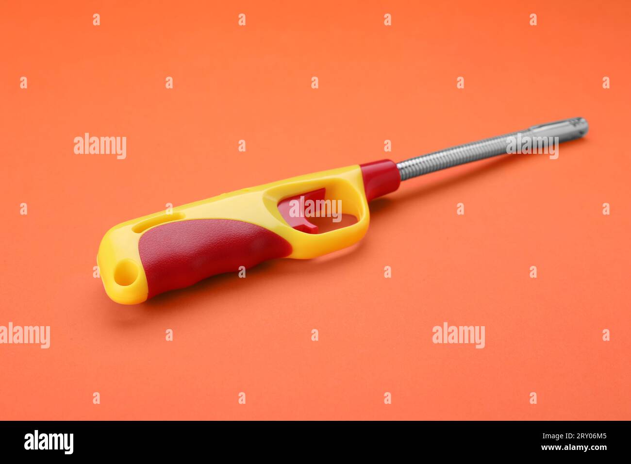One bright gas lighter on orange background Stock Photo - Alamy