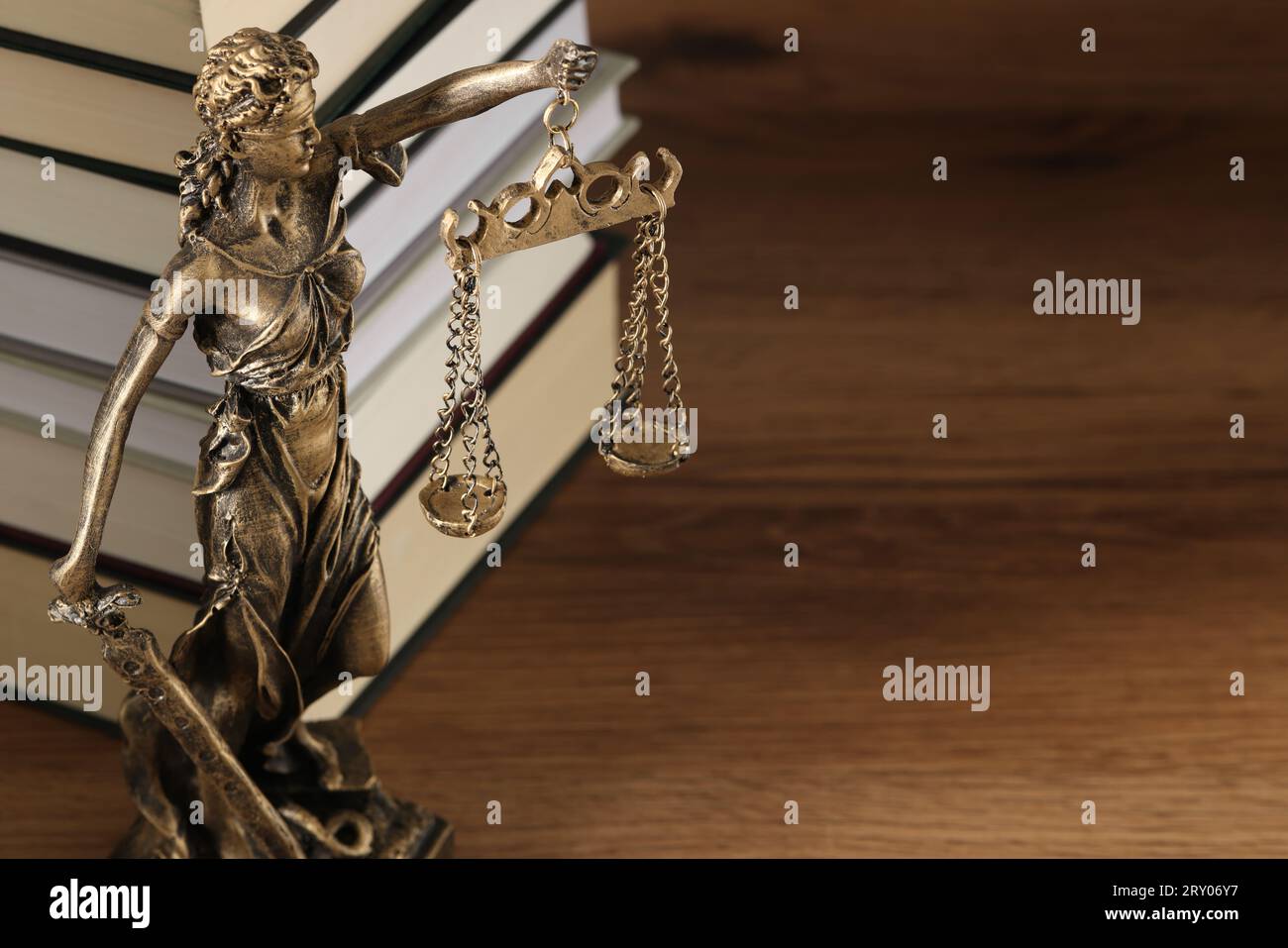 Symbol of fair treatment under law. Figure of Lady Justice and books on ...