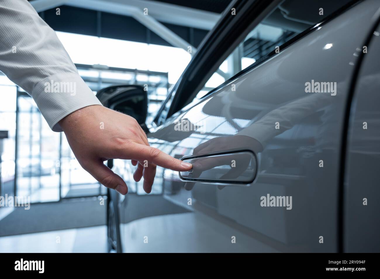 A man opens a car door with a fingerprint. Integrated handle Stock ...
