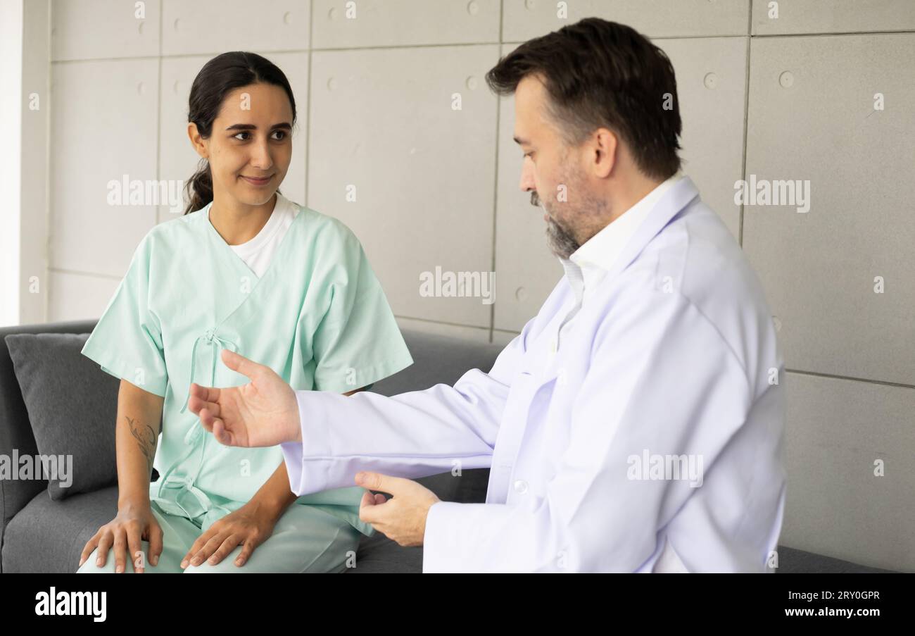 Caucasian doctor working as physiotherapist for stretching and ...