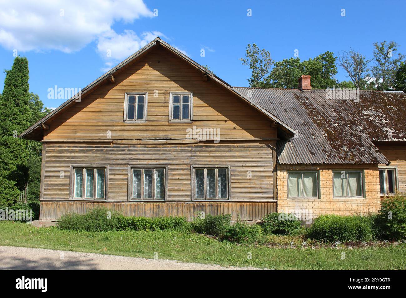 Traditional Latvian wood and brick village home in light orange in ...