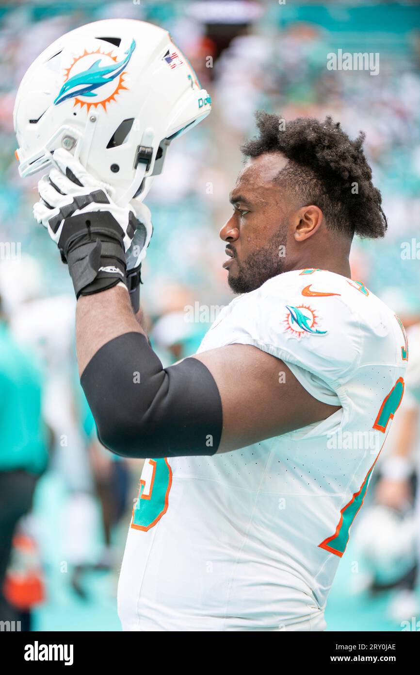 Miami Dolphins offensive lineman Austin Jackson (73) puts on his helmet on the sidelines during ...