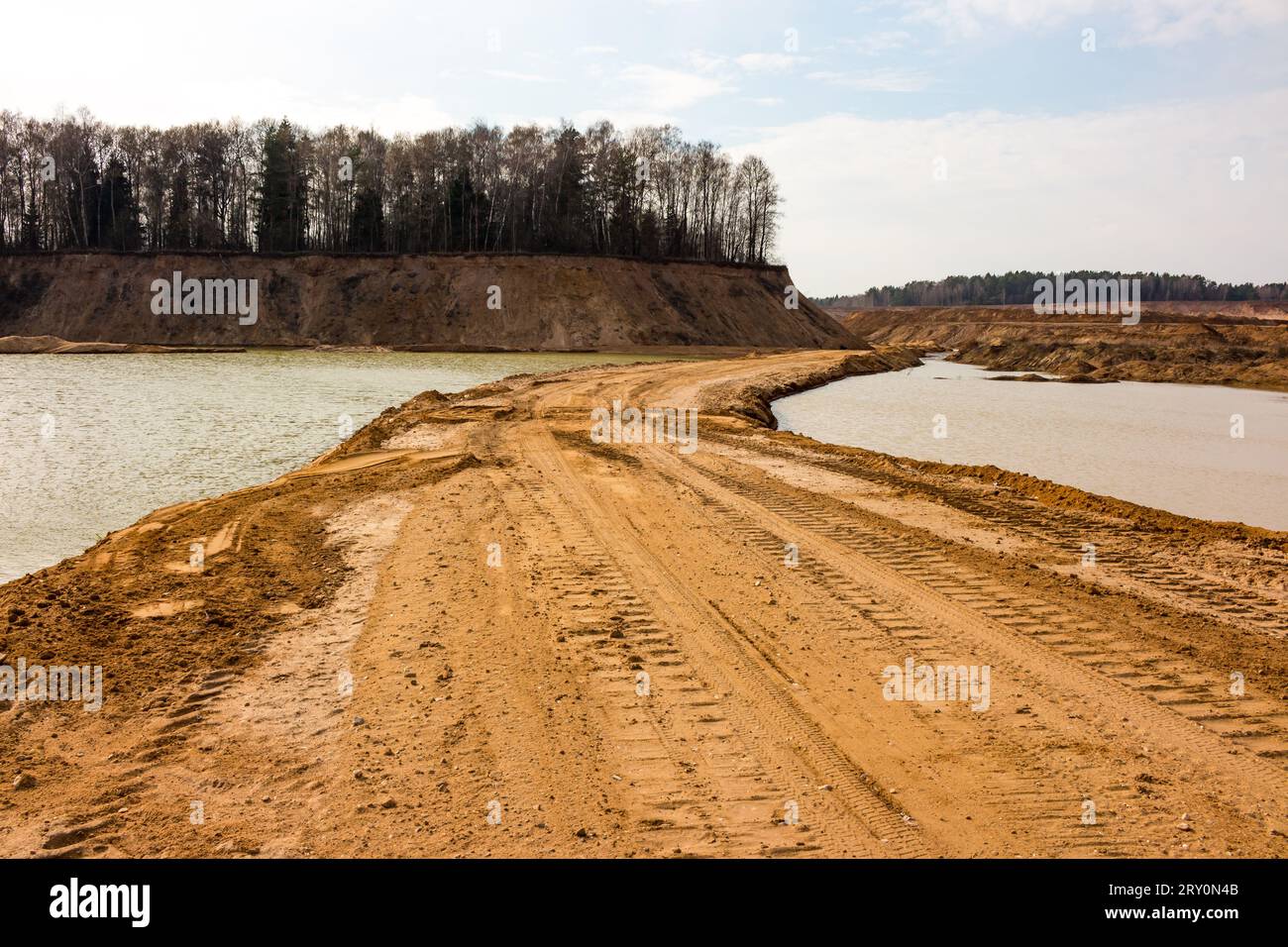Causeway for cargo trucks at a sand quarry Stock Photo - Alamy
